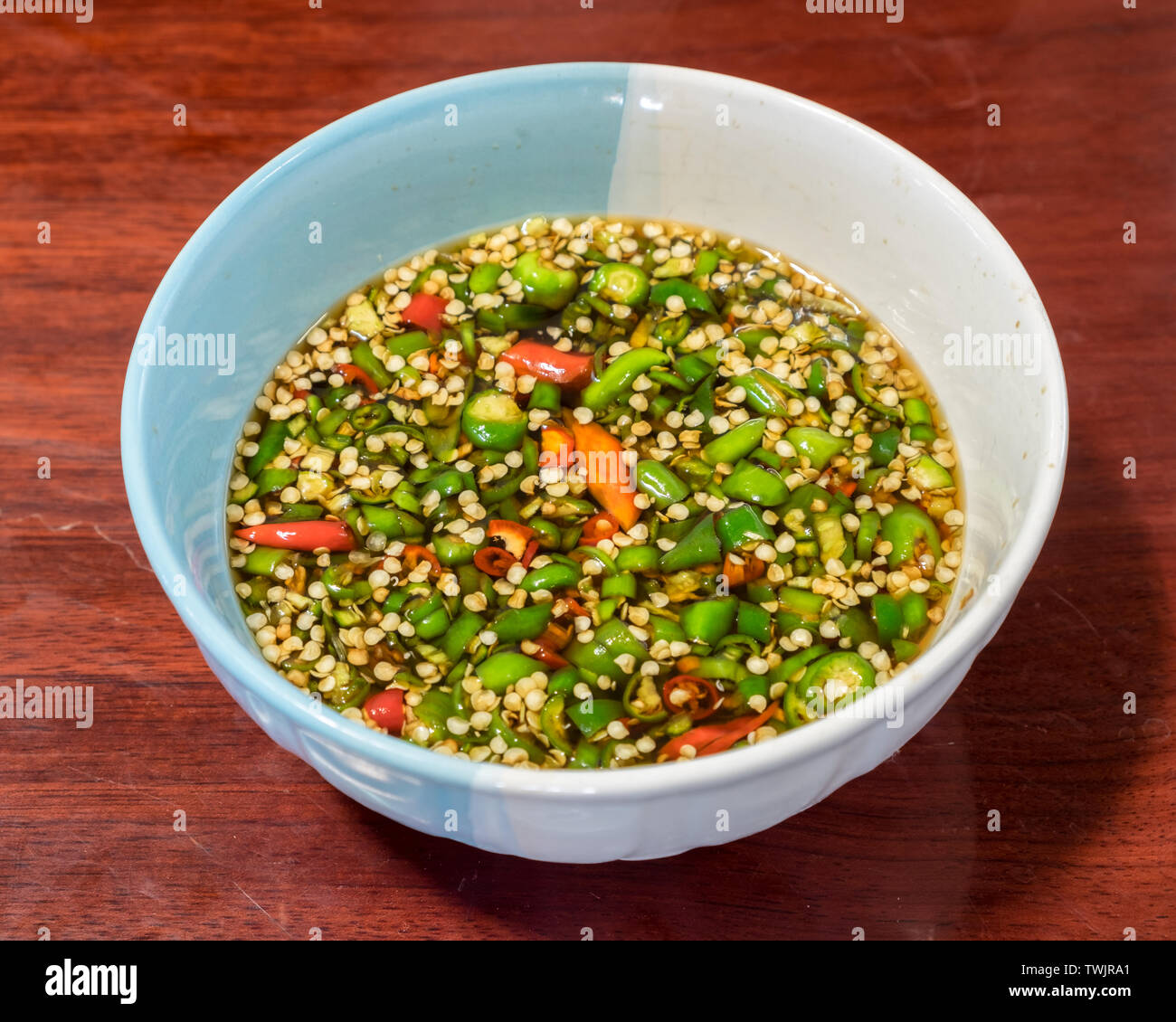 Garnish chilli sliced on salt sauce in ceramic cup Stock Photo - Alamy