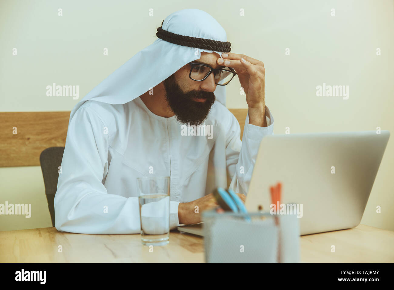 Arab saudi businessman working online with a laptop and tablet in his ...