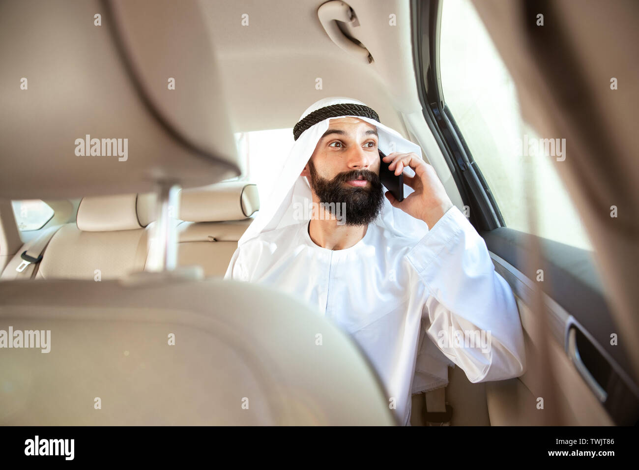 Arab saudi businessman working online with a smartphone, calling his ...