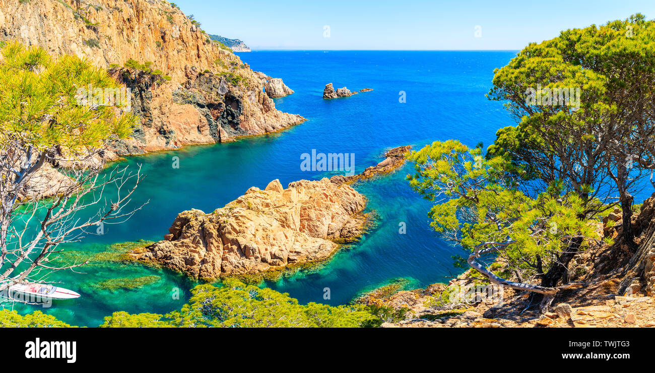Panoramic view of white motorboat in beautiful sea cove of Cala ...