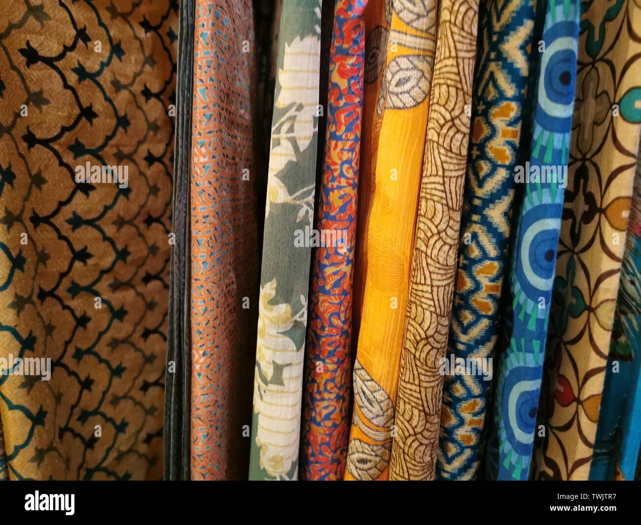 many colors indian fabric clothes at the market detail Stock Photo - Alamy