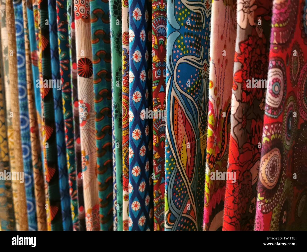 many colors indian fabric clothes at the market detail Stock Photo - Alamy