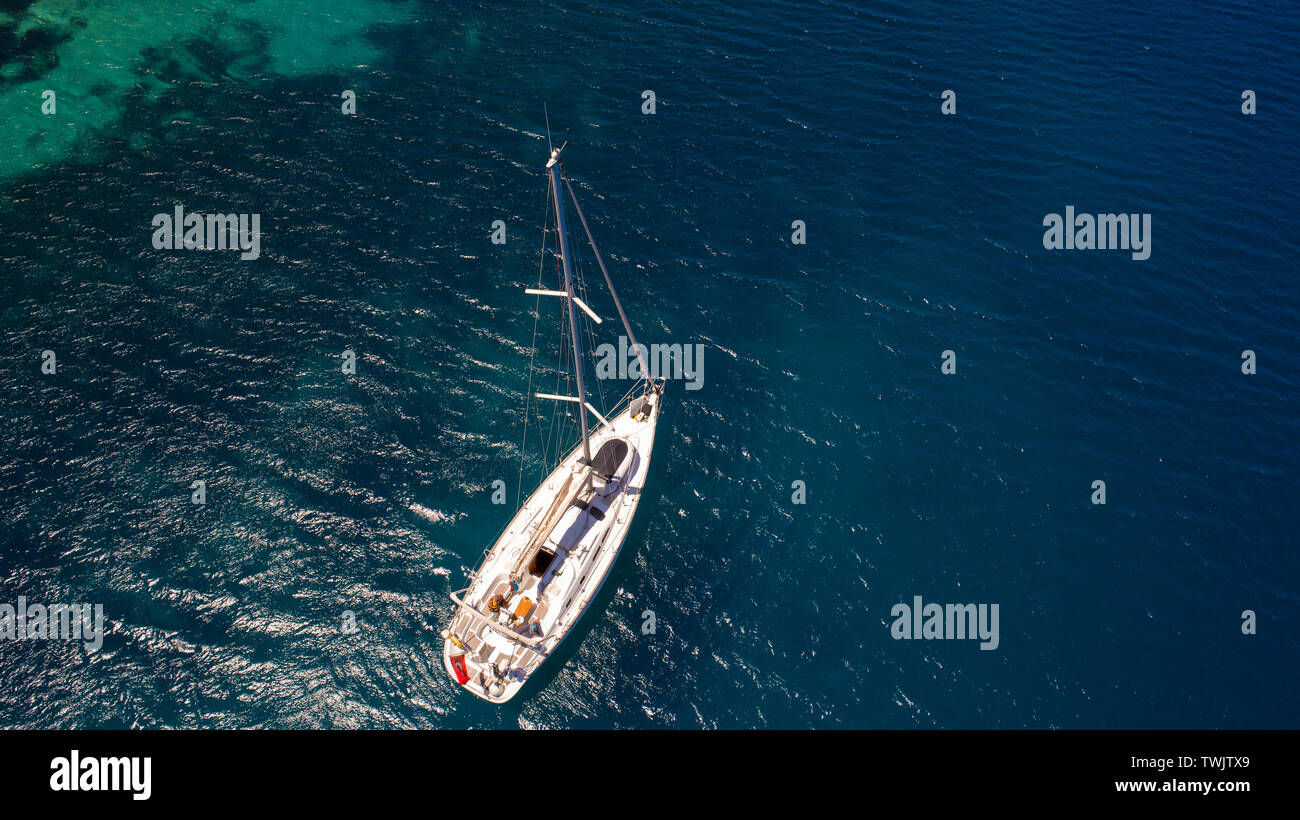 Aerial view of sea and yacht. Sailing ship in the middle of ocean, top ...