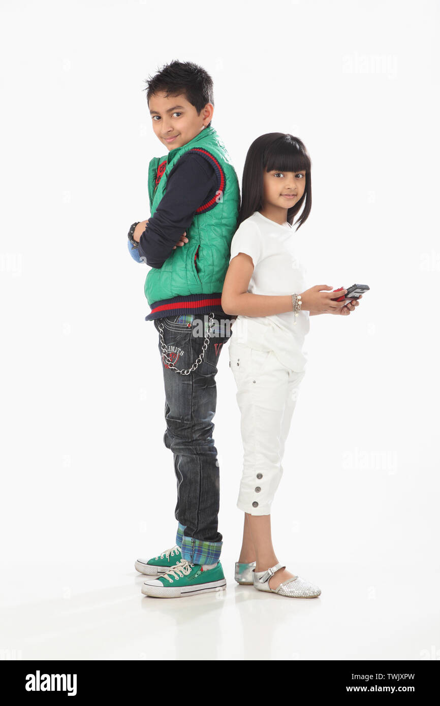 Two children standing back to back Stock Photo - Alamy