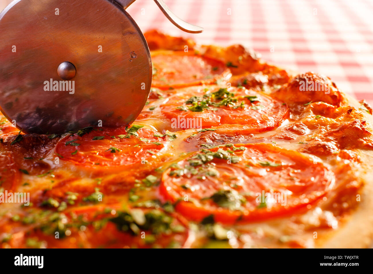 Close up Cuts with a pizza cutter. Pizza Margarita. Delicious hot food ...