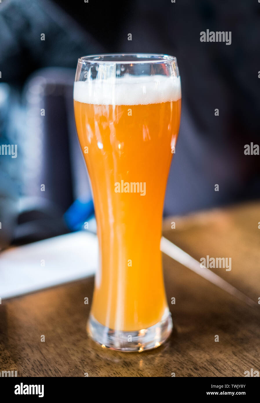 Yellow draft beer with foam in glass on wooden table Stock Photo - Alamy