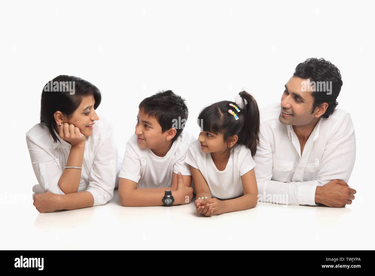 Family lying down in a row Stock Photo - Alamy