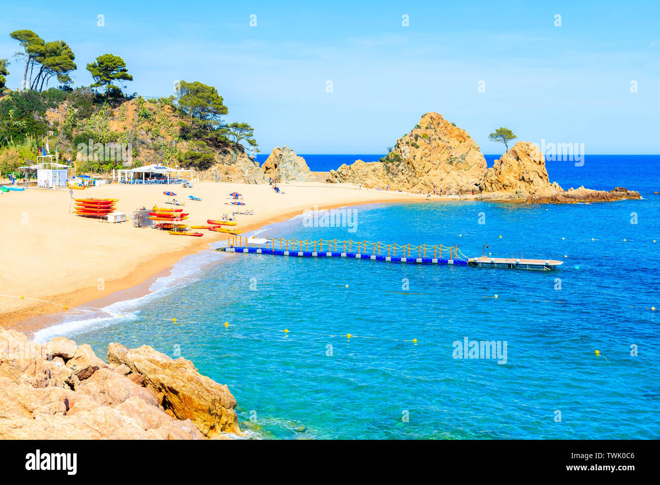 Azure blue water on idyllic beach in Tossa de Mar town, Costa Brava ...
