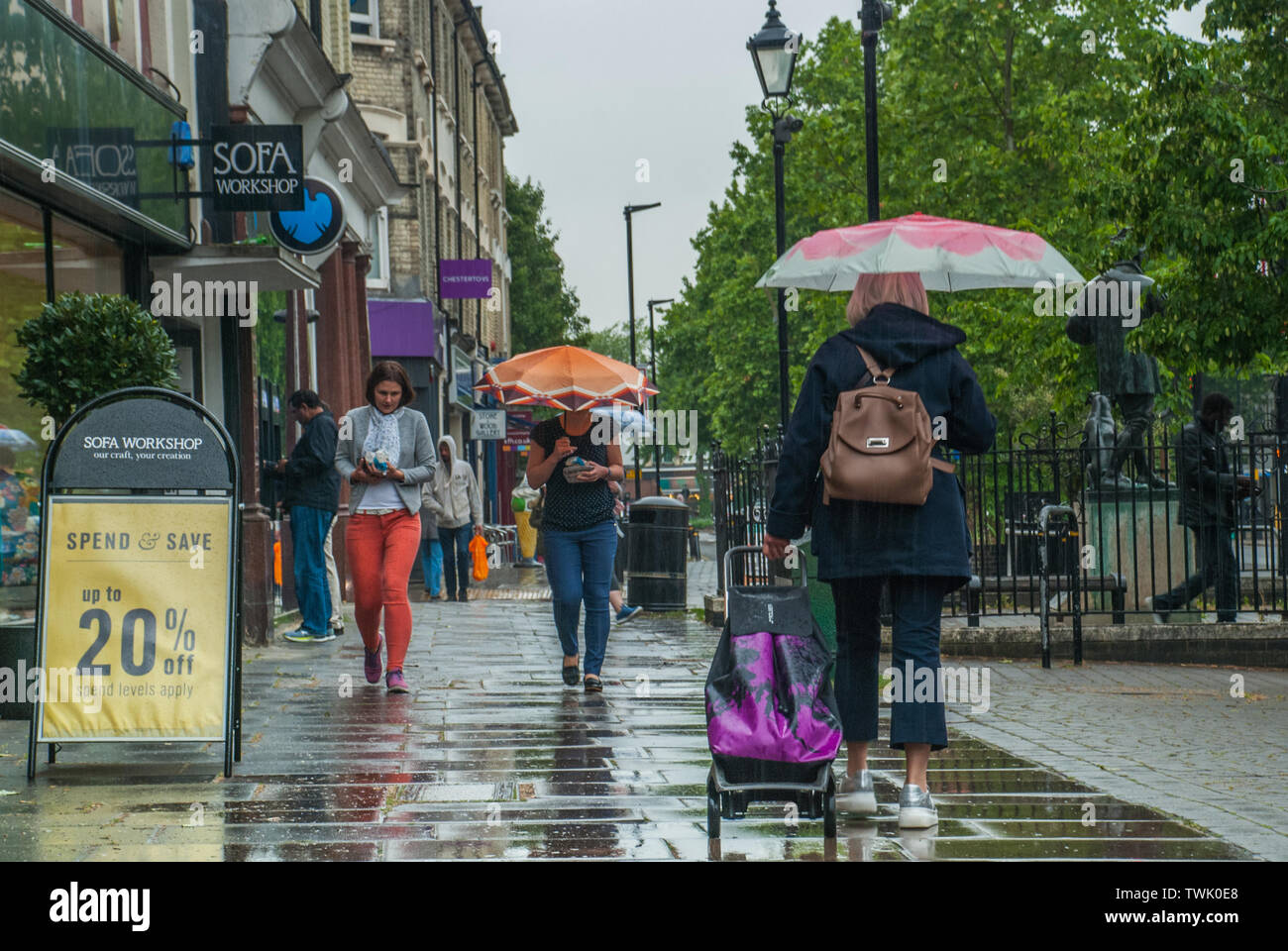 LONDON, UK - JUN 5, 2019 : Pedestrians protect themself from the rain ...