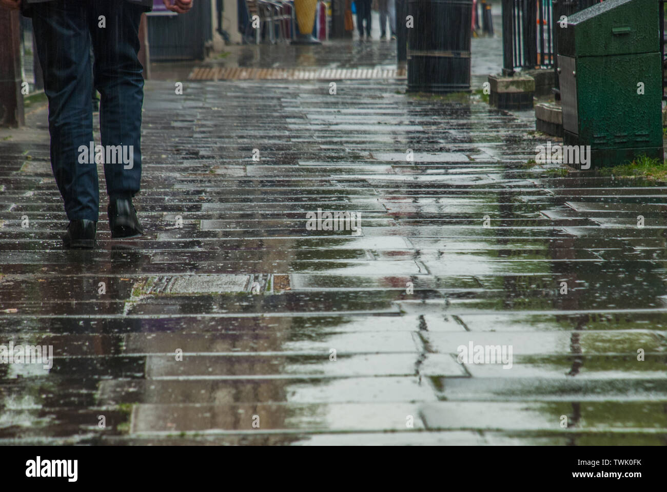 LONDON, UK - JUN 5, 2019 : Pedestrian feet walking in the rain in ...