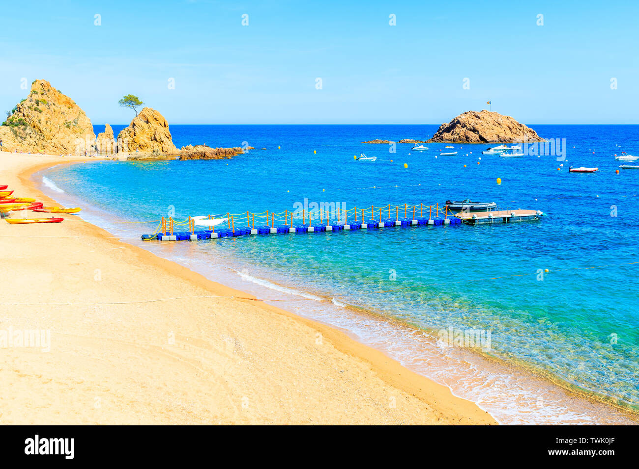 Azure blue water on idyllic beach in Tossa de Mar town, Costa Brava ...