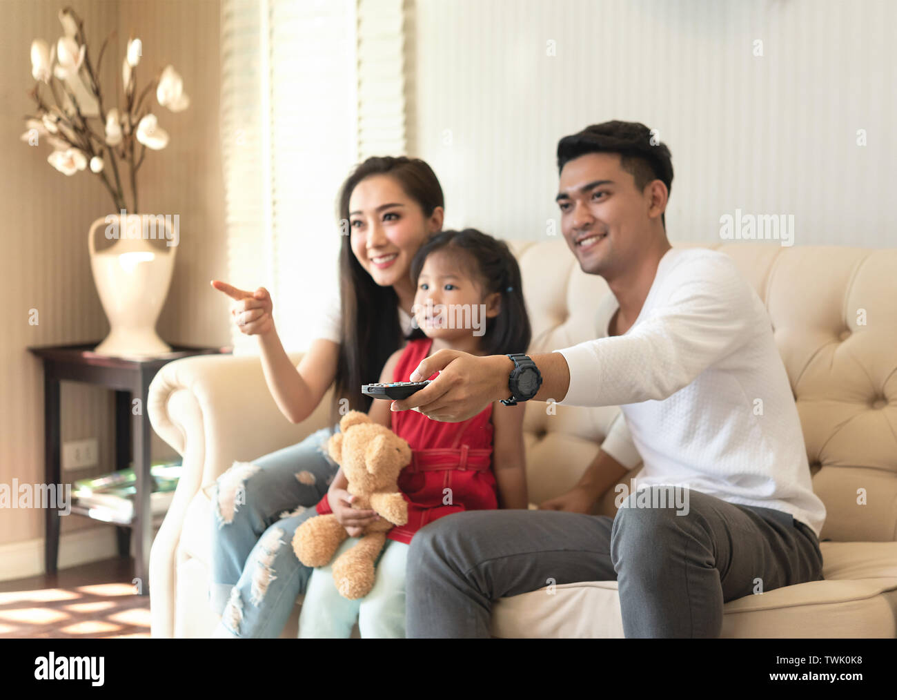 happy family watching television together in living room at home Stock ...