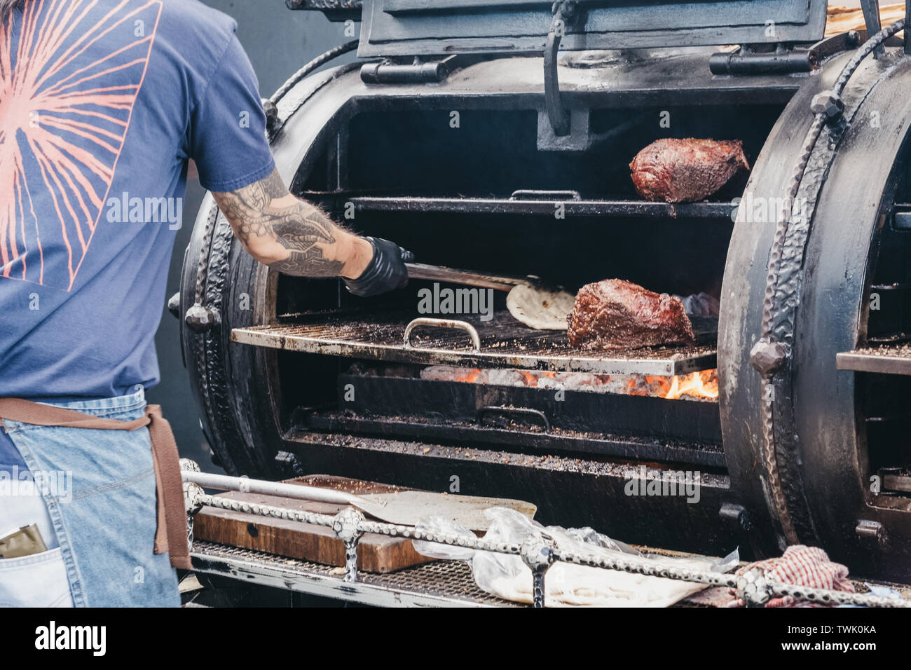 London, UK - June 15, 2019: Staff preparing food at a Smokoloco stall ...