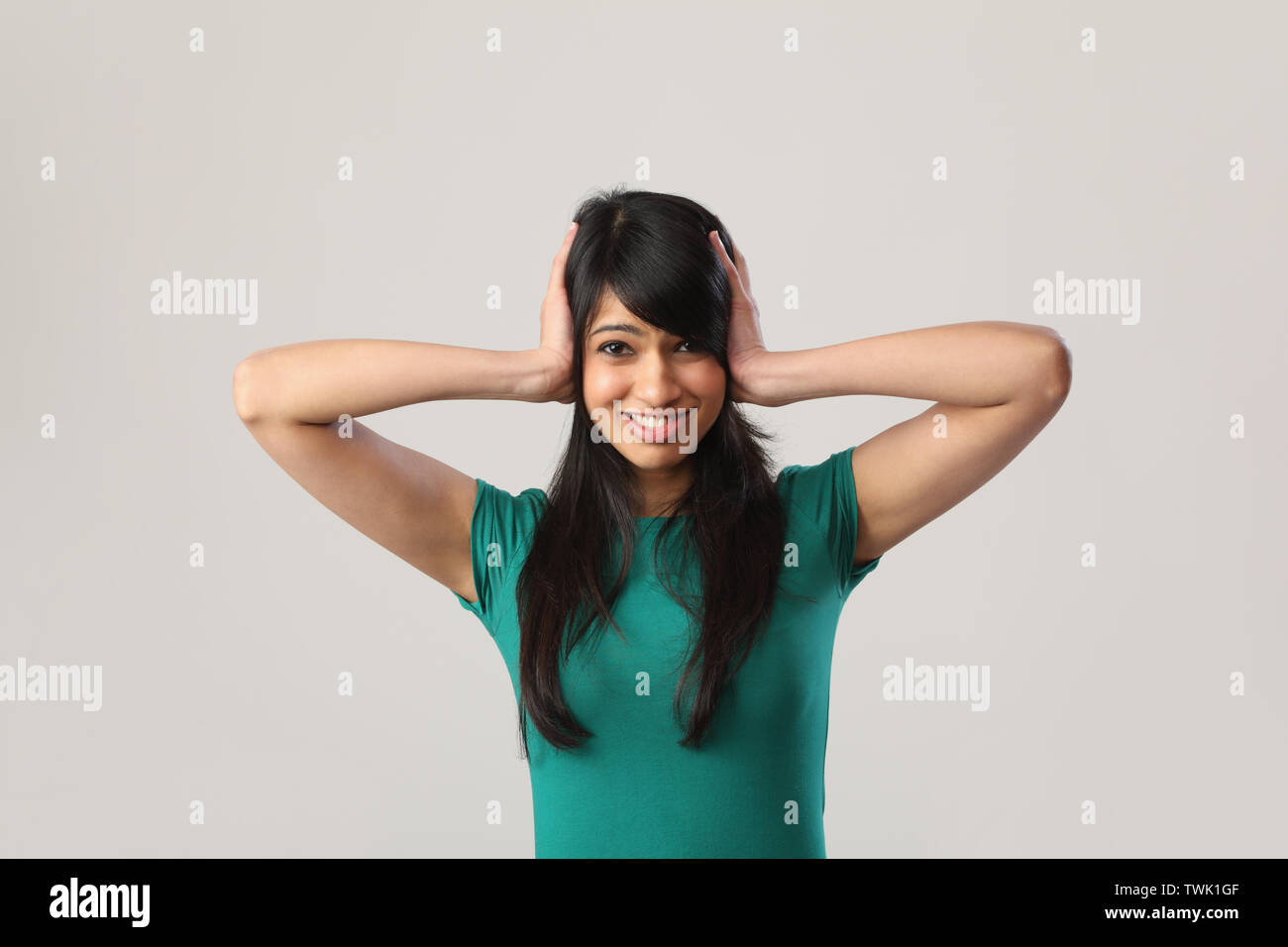 Woman covering ears with hands Stock Photo - Alamy