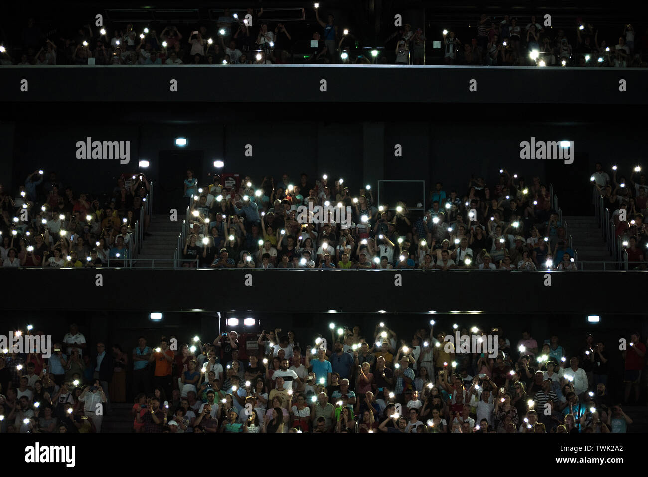 CLUJ, ROMANIA - JUNE 15, 2019: Crowd of people waving hands with their ...