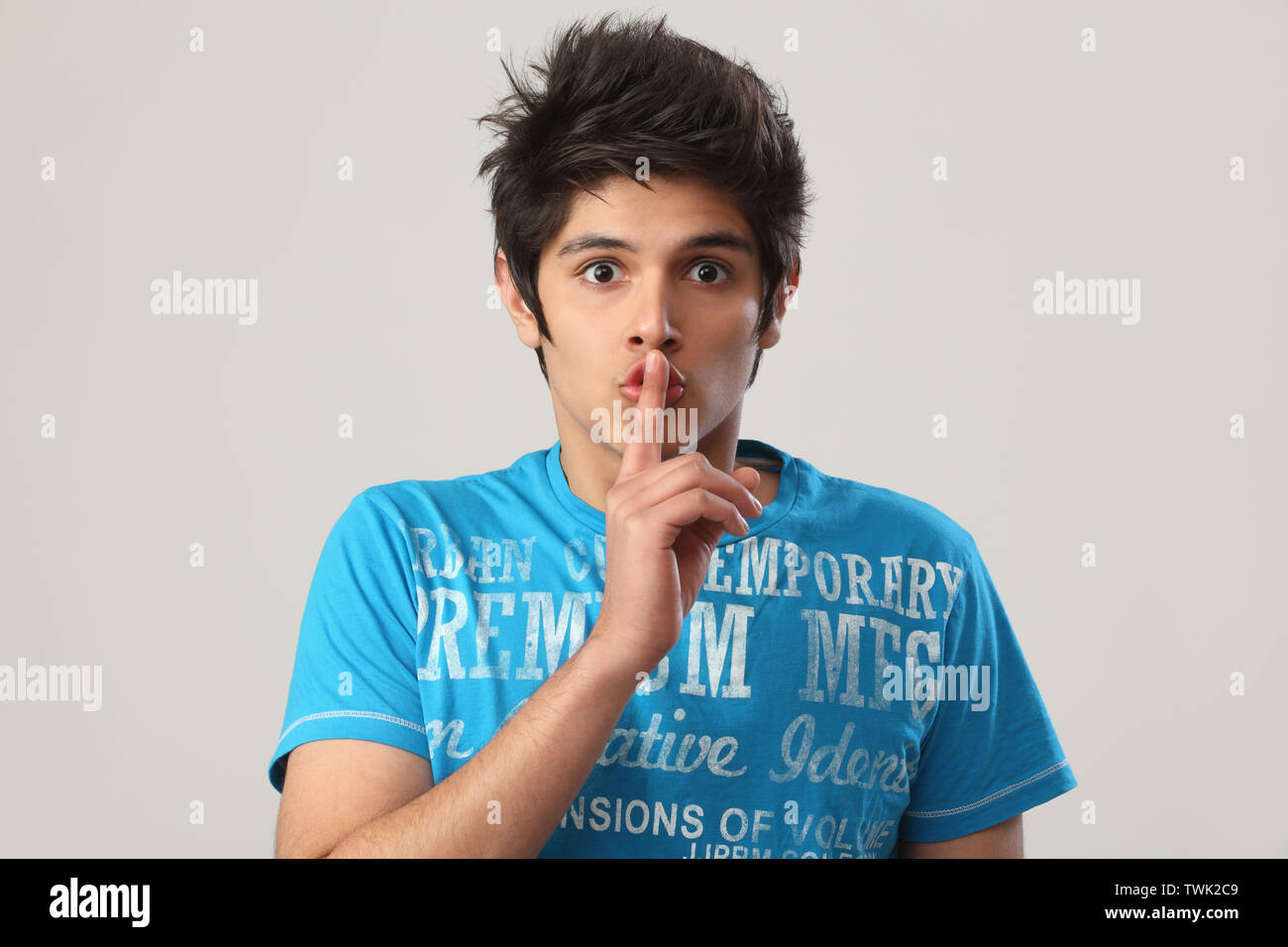 Portrait of a man with a finger on lips Stock Photo - Alamy