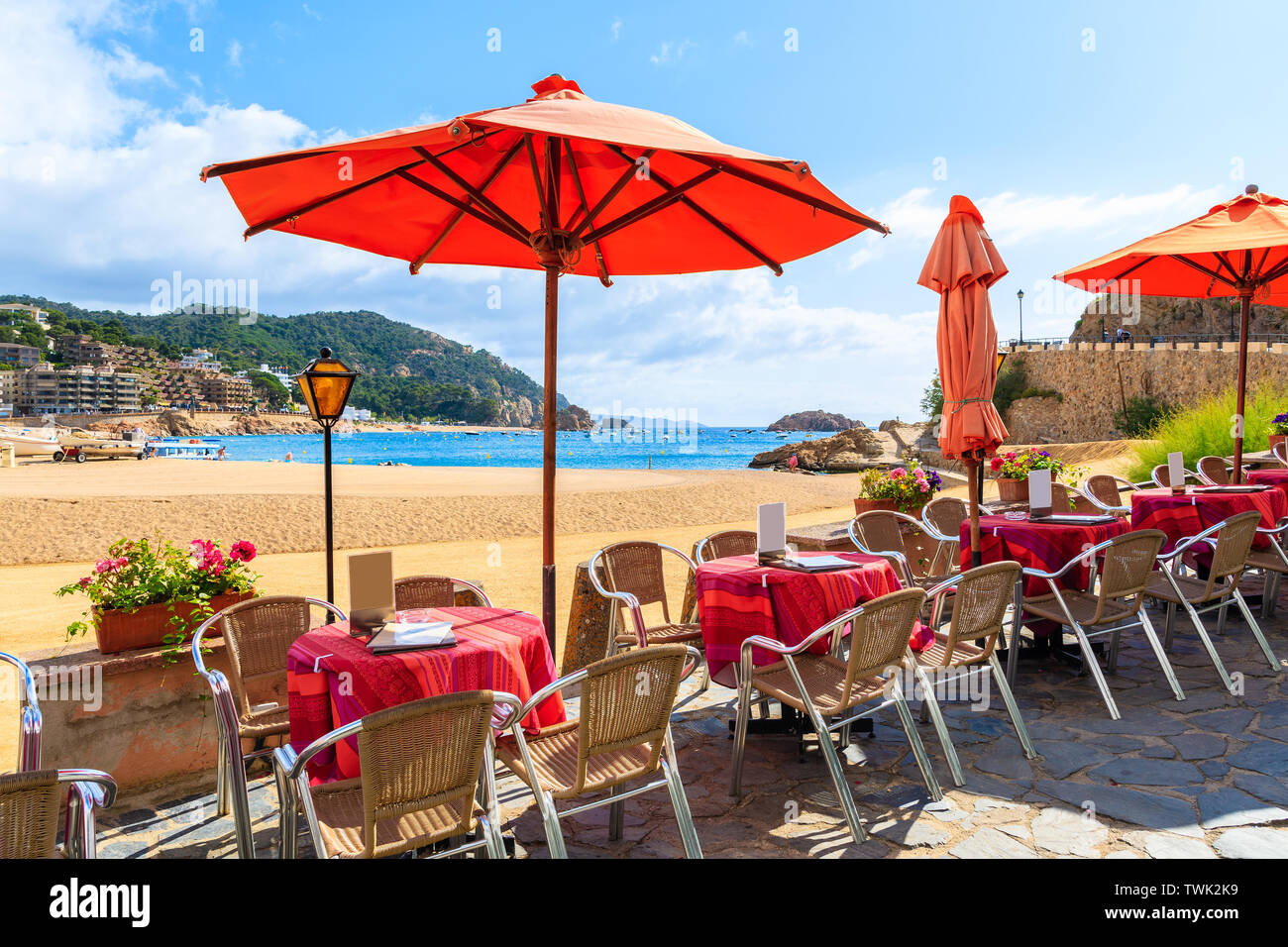 Restaurant tables on beach of Tossa de Mar which is a seaside resort on ...