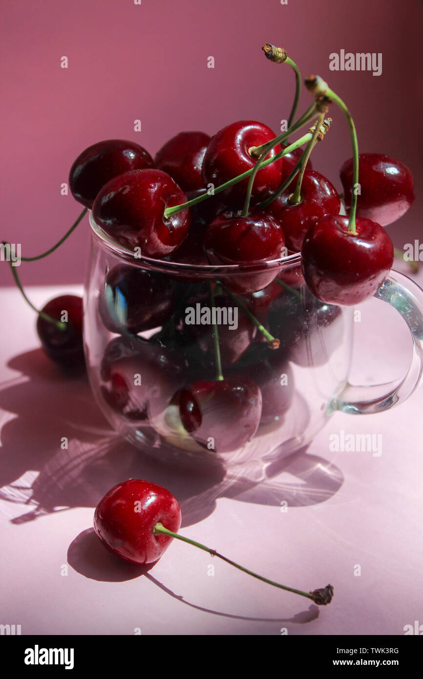 Cherries in transparent bowl, pink background. Red cherry. Fresh ...