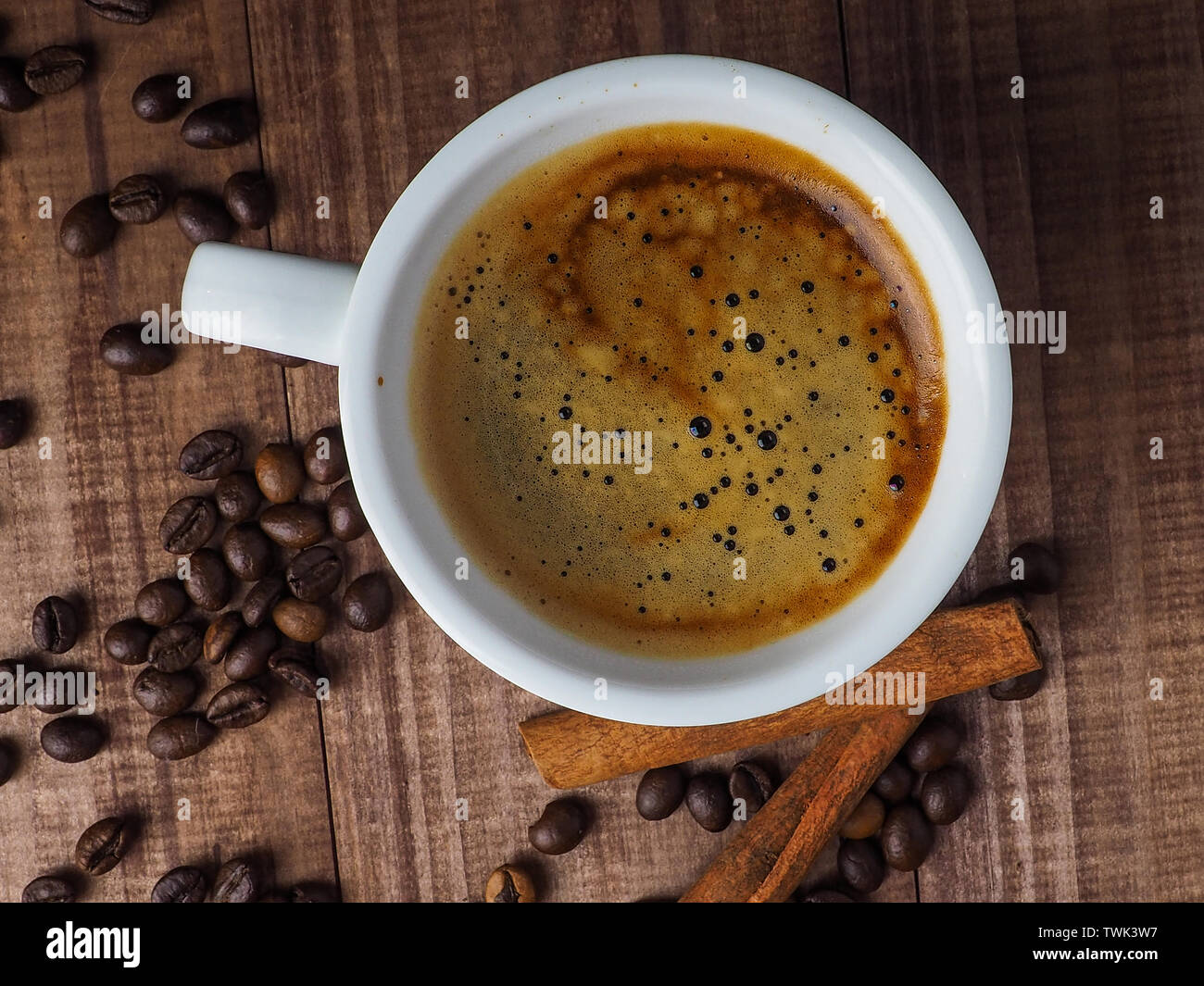 Coffee cup and coffee beans on table Stock Photo - Alamy
