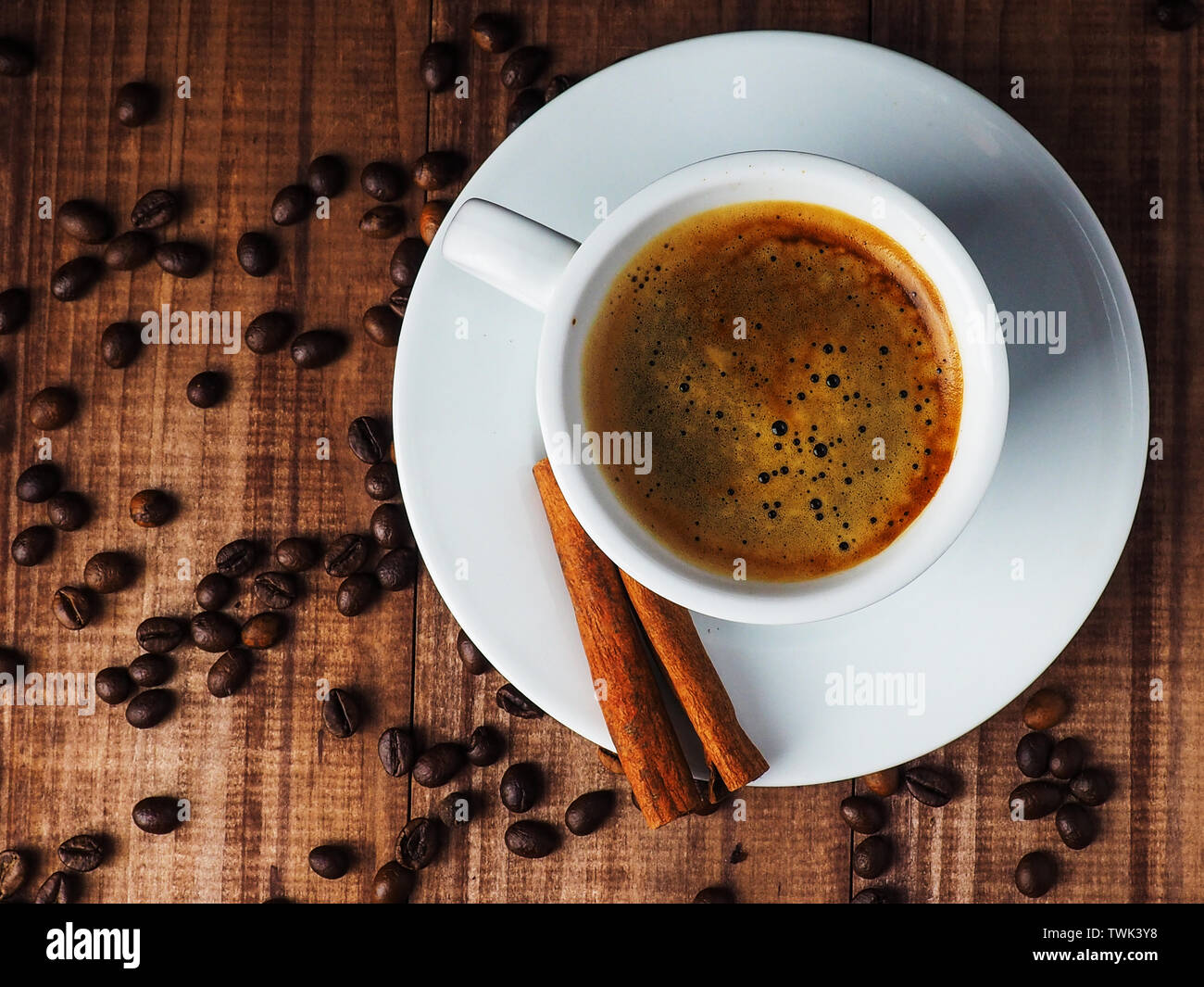 Coffee cup and coffee beans on table Stock Photo - Alamy