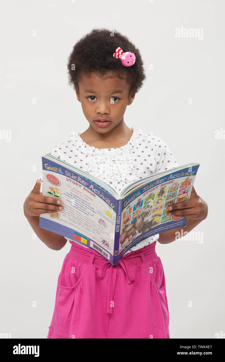 Portrait of a schoolgirl reading a book Stock Photo - Alamy