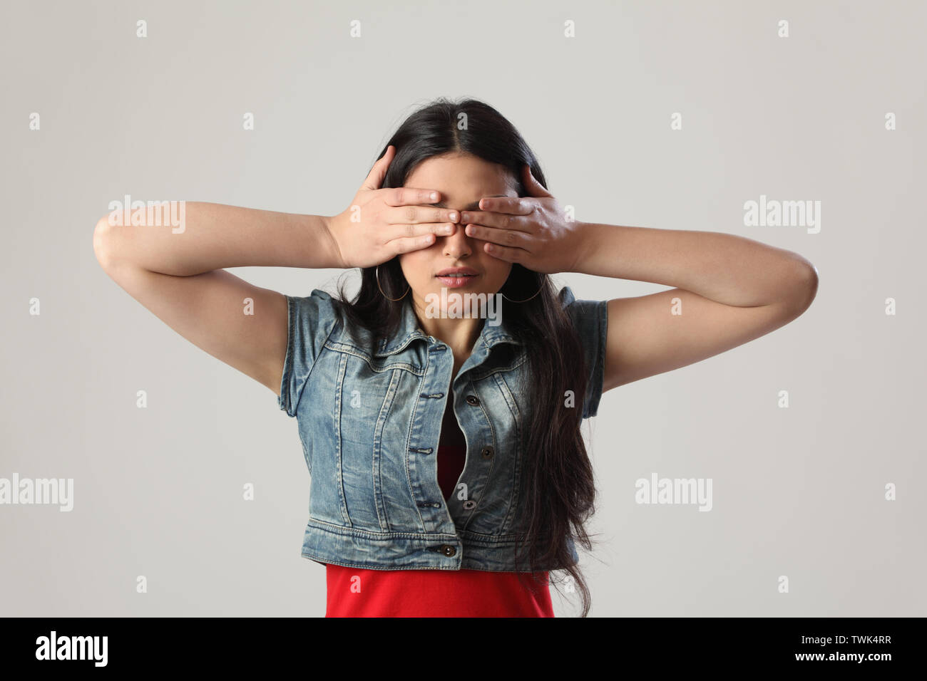 Woman covering eyes with hands Stock Photo - Alamy