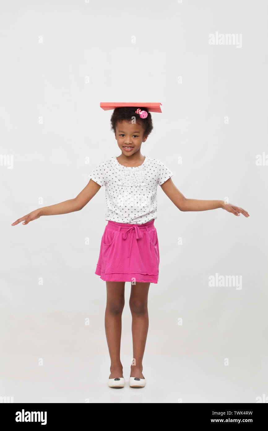 Girl balancing a book on her head Stock Photo - Alamy