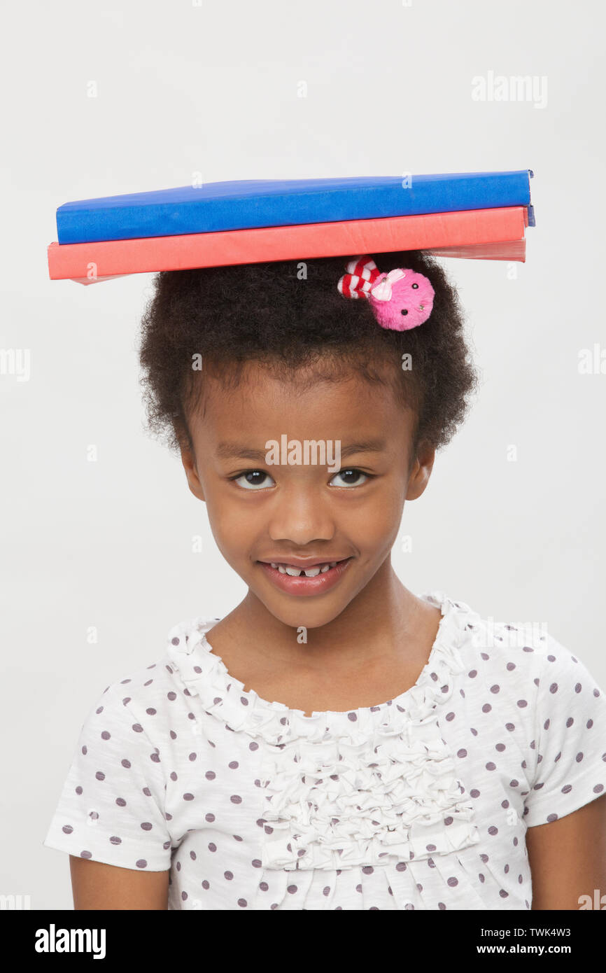 Children balancing book on head hi-res stock photography and images - Alamy
