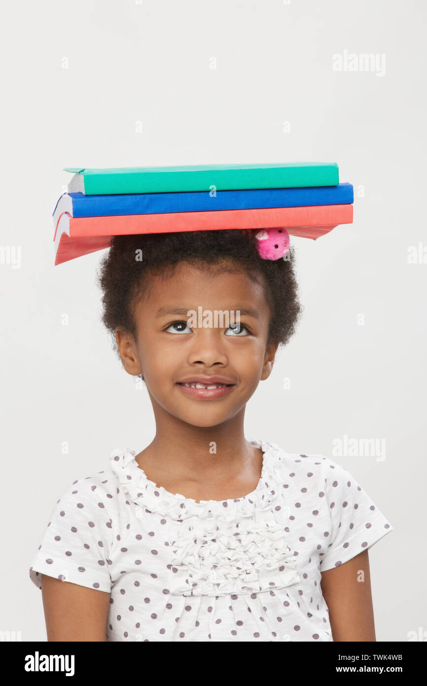 Children balancing book on head hi-res stock photography and images - Alamy