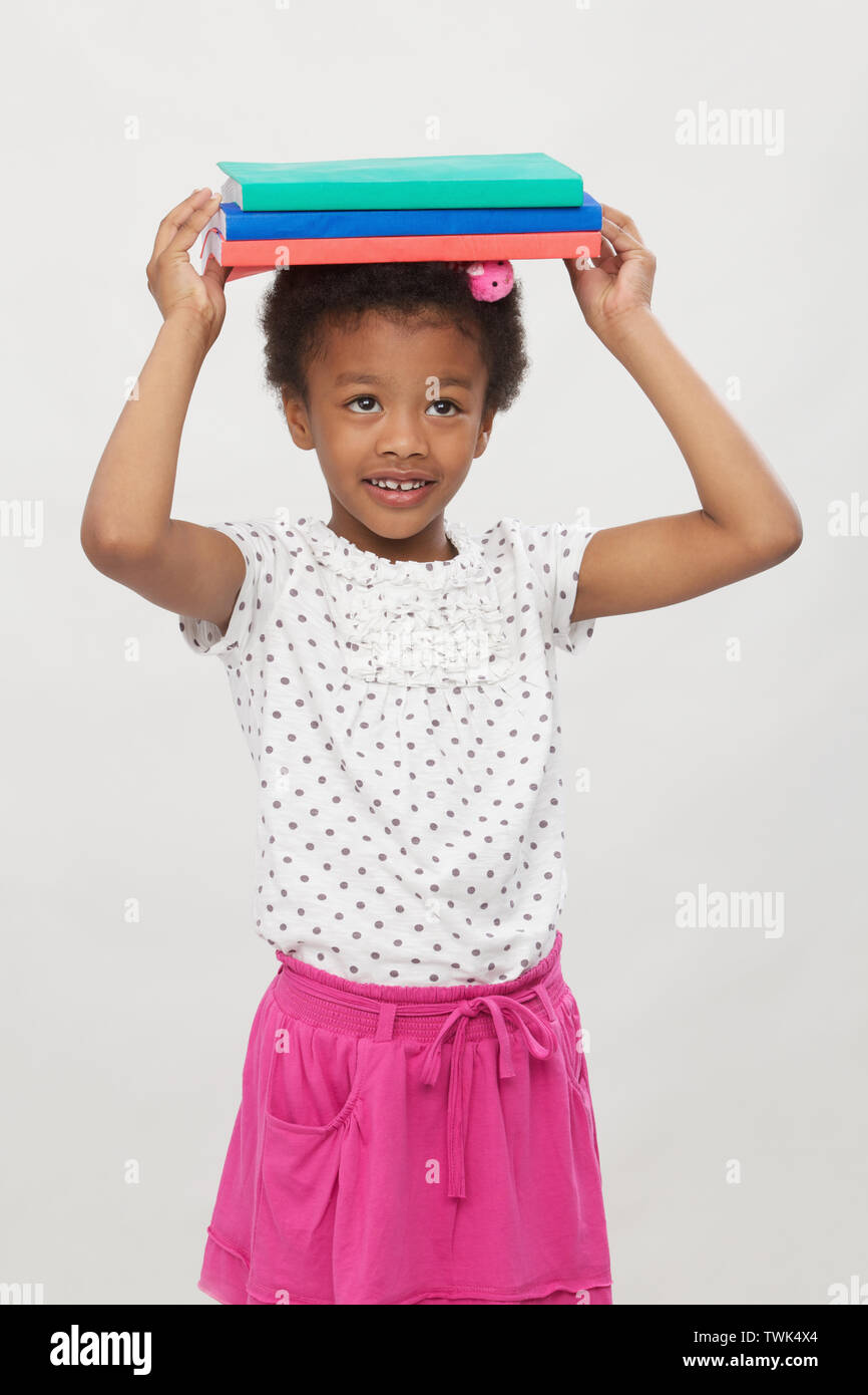 Children balancing book on head hi-res stock photography and images - Alamy