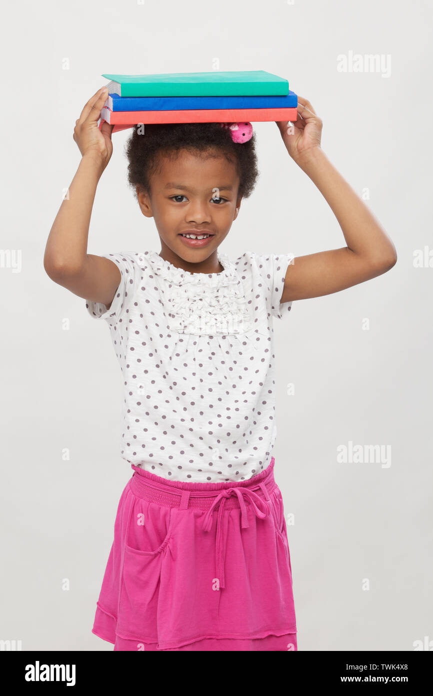 Children balancing book on head hi-res stock photography and images - Alamy