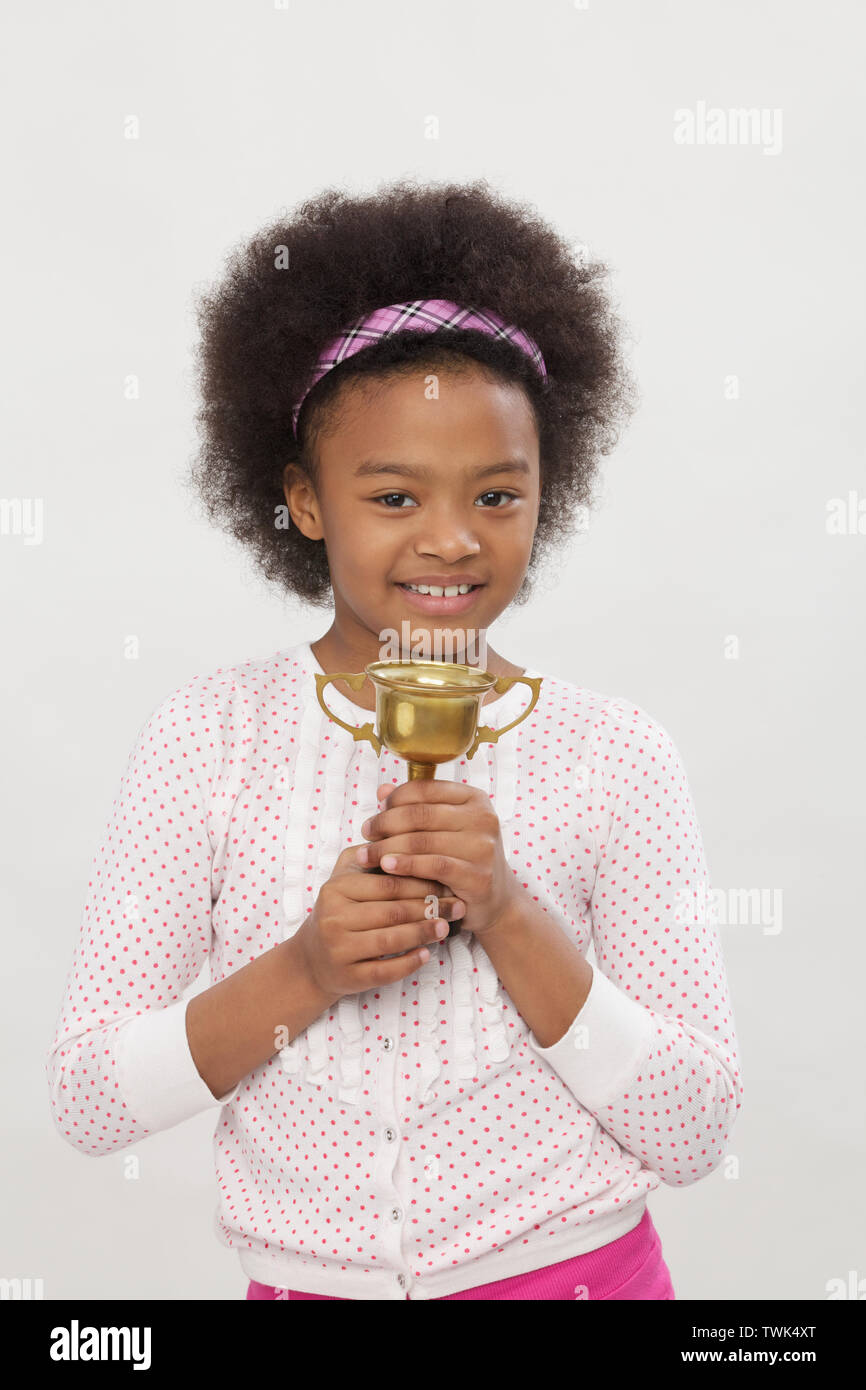 Portrait of a girl holding a trophy Stock Photo - Alamy