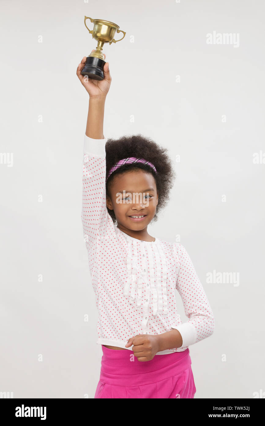 Girl holding trophies hi-res stock photography and images - Alamy