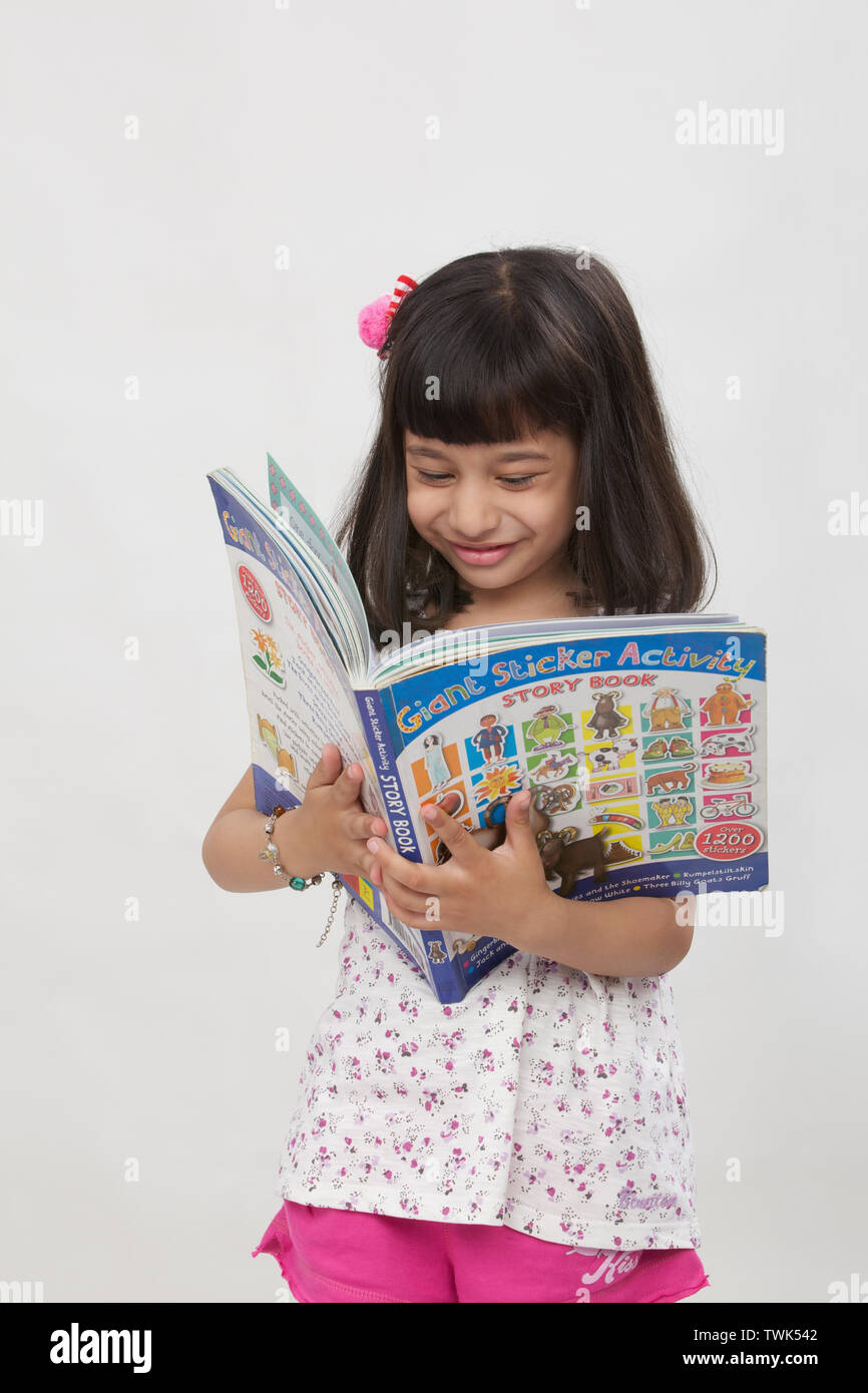Girl reading a book Stock Photo - Alamy