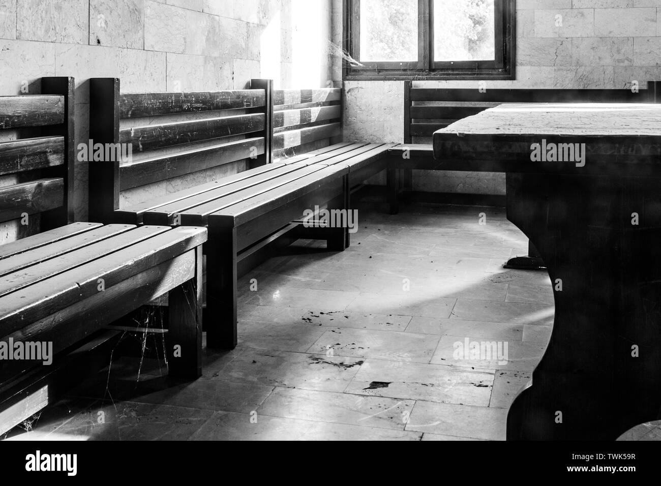 Retro waiting room with wooden table and benches at station in Kőszeg ...