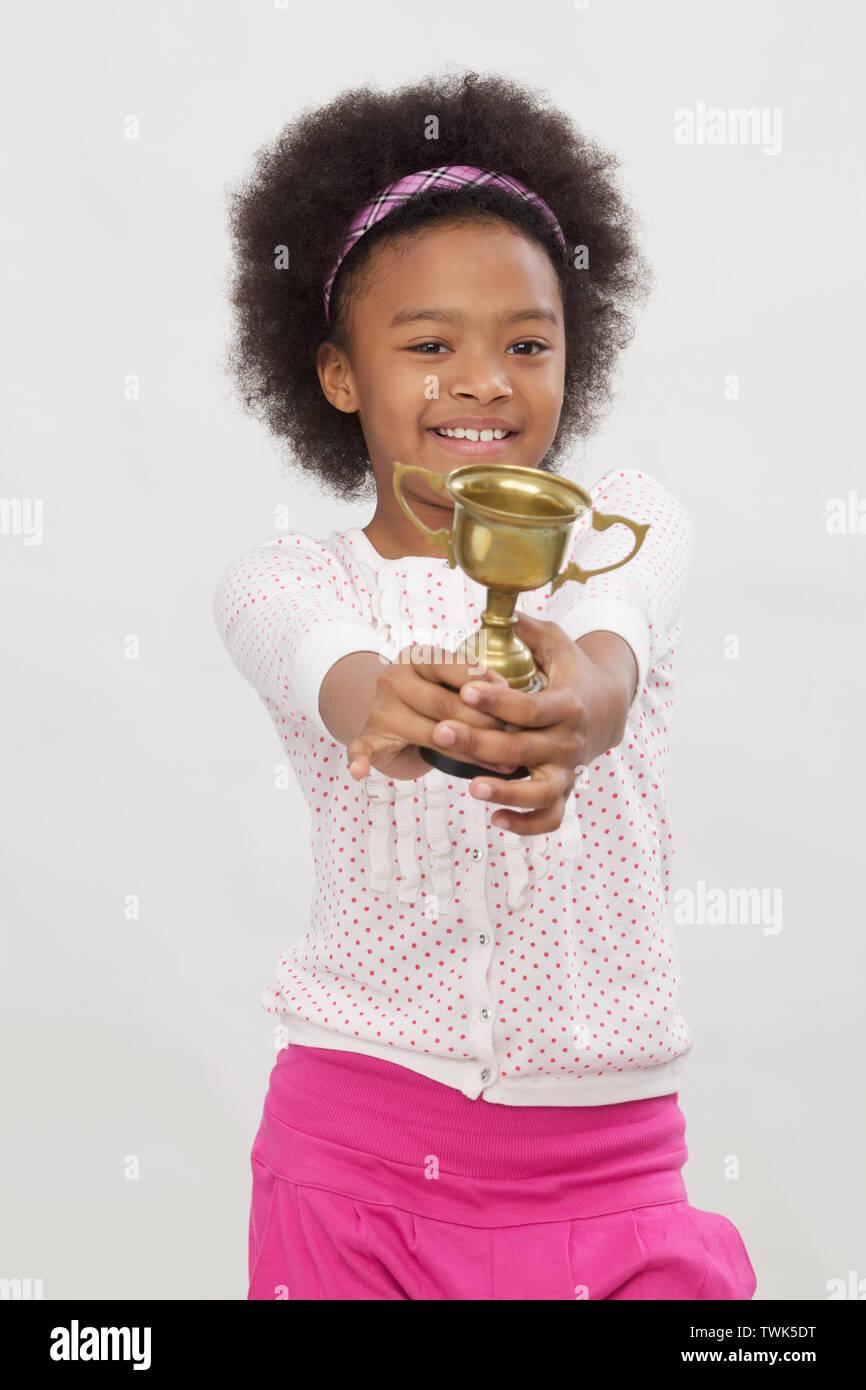Girl showing winning trophy hi-res stock photography and images - Alamy