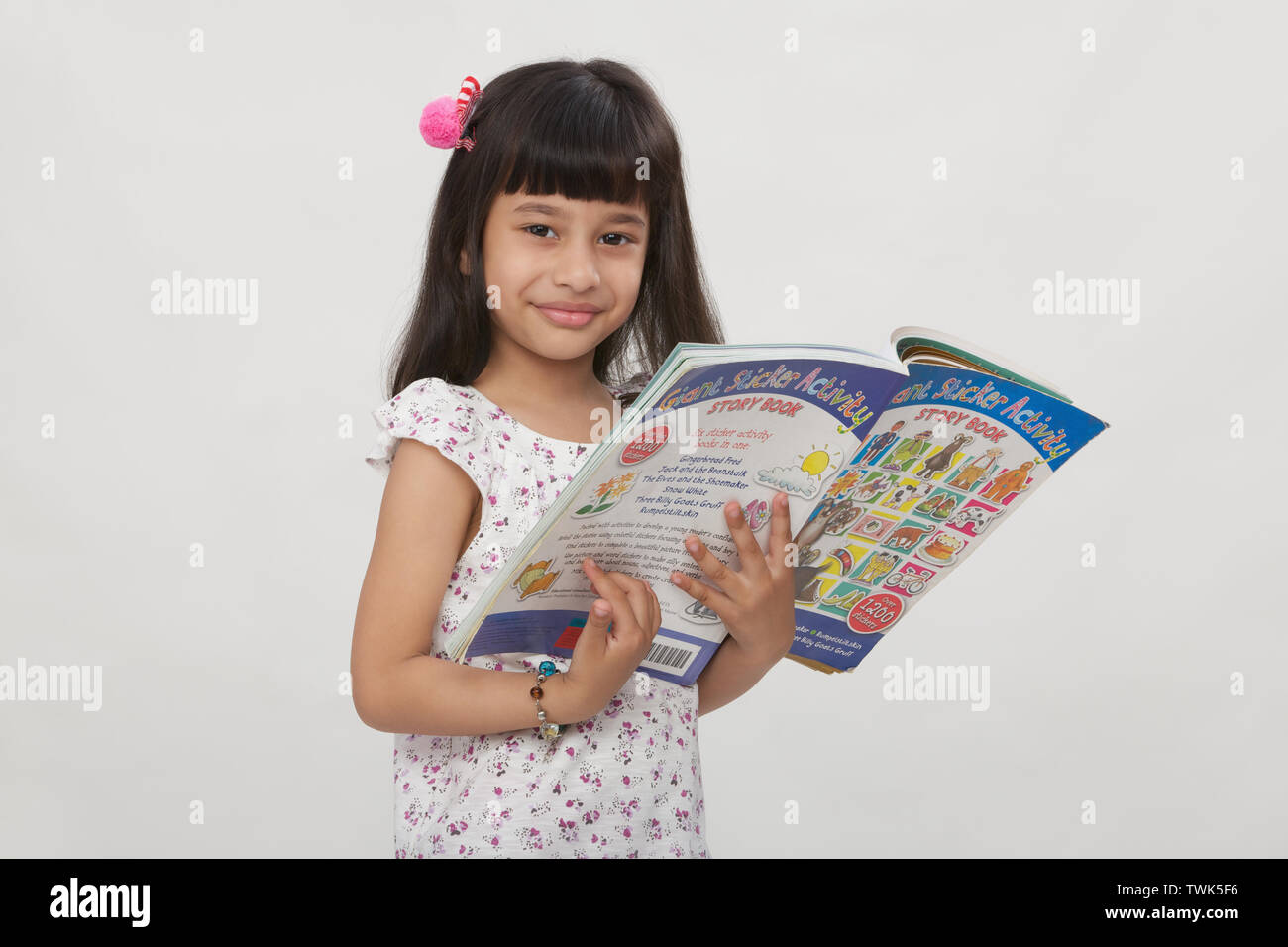 Girl holding opened book hi-res stock photography and images - Alamy