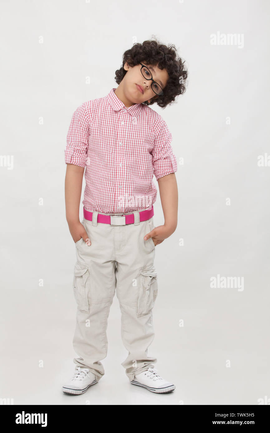 Boy standing with hands in pockets Stock Photo - Alamy