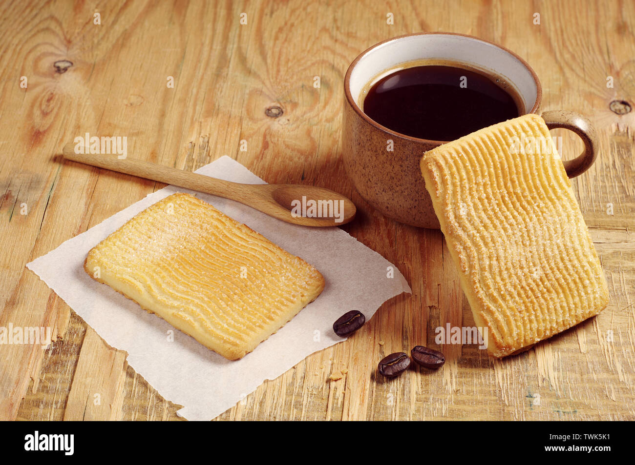 Cup of hot coffee with sweet cookies on old wooden table Stock Photo ...