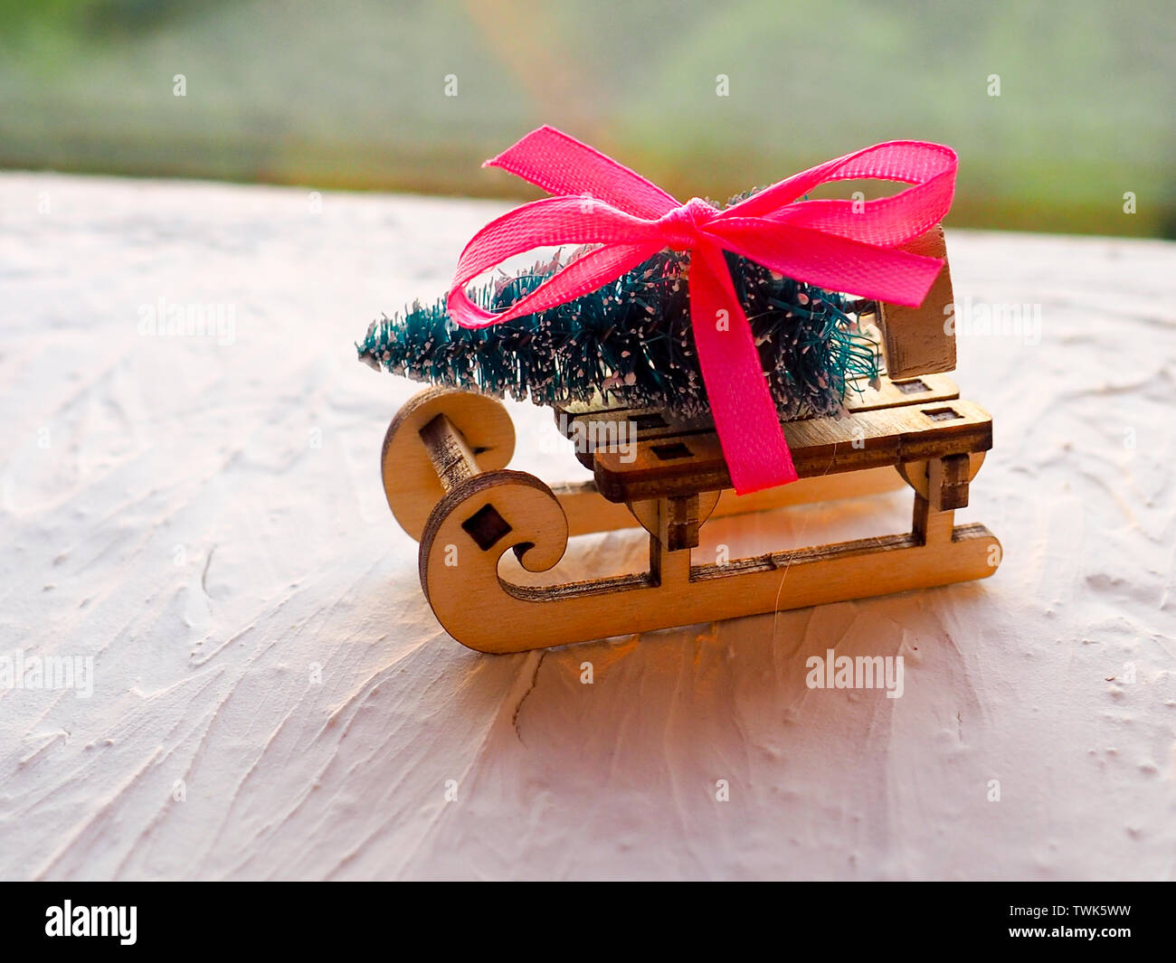 small Christmas tree on a sled on a white background, concept Christmas ...