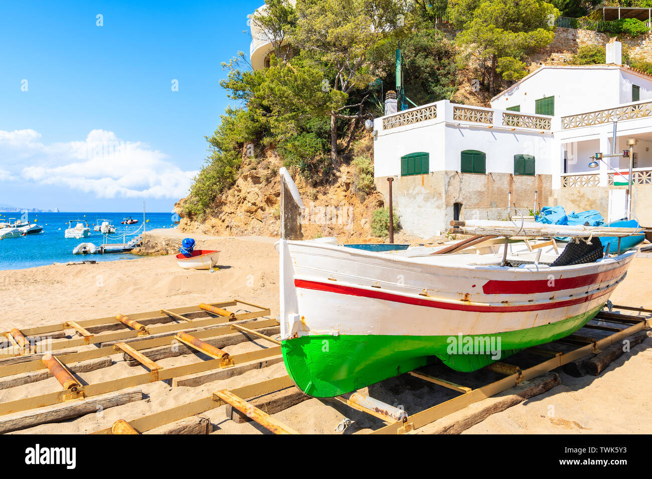 Traditional white and red colour fishing boat on Sa Riera beach with ...