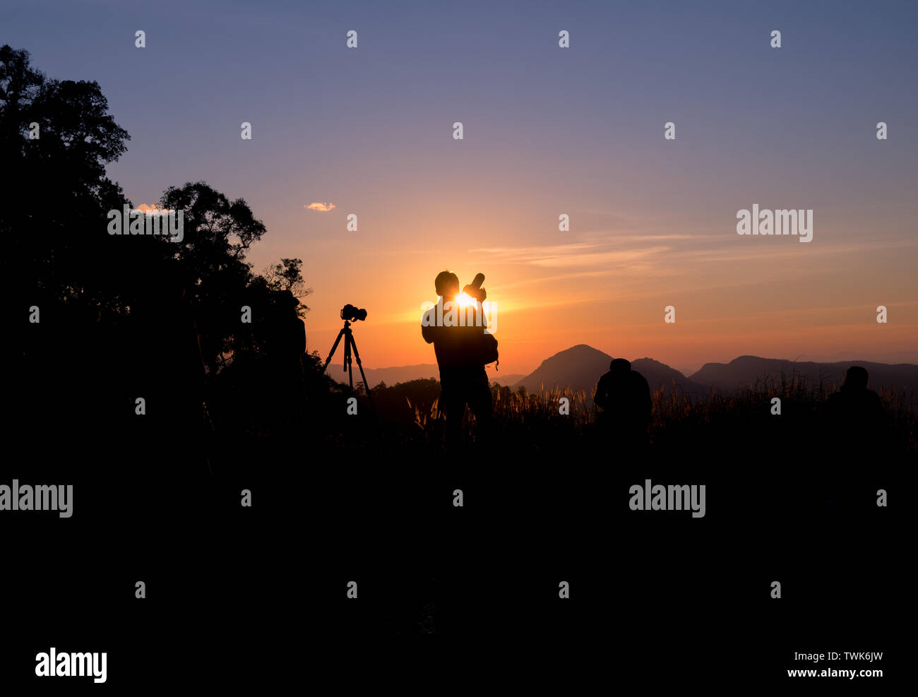 Photographer stand waiting to capture at sunset Stock Photo - Alamy