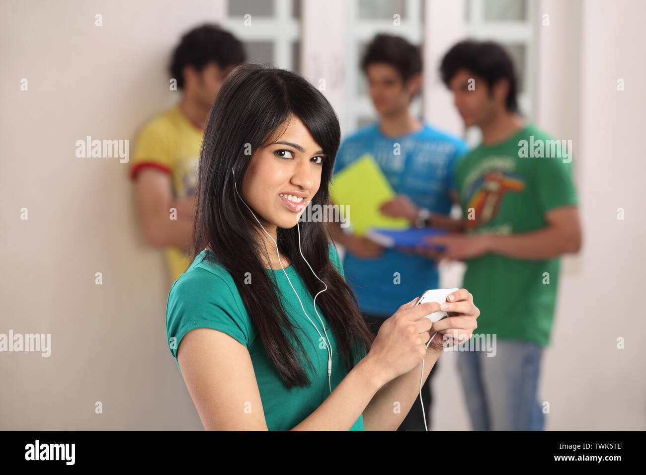 College student listening to music with a mobile phone Stock Photo - Alamy