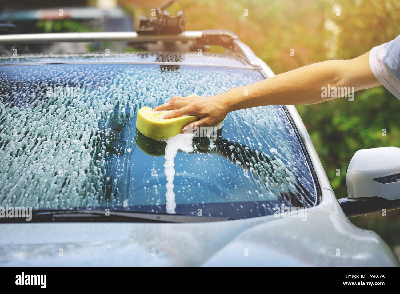hand car wash - washing windshield with sponge Stock Photo - Alamy