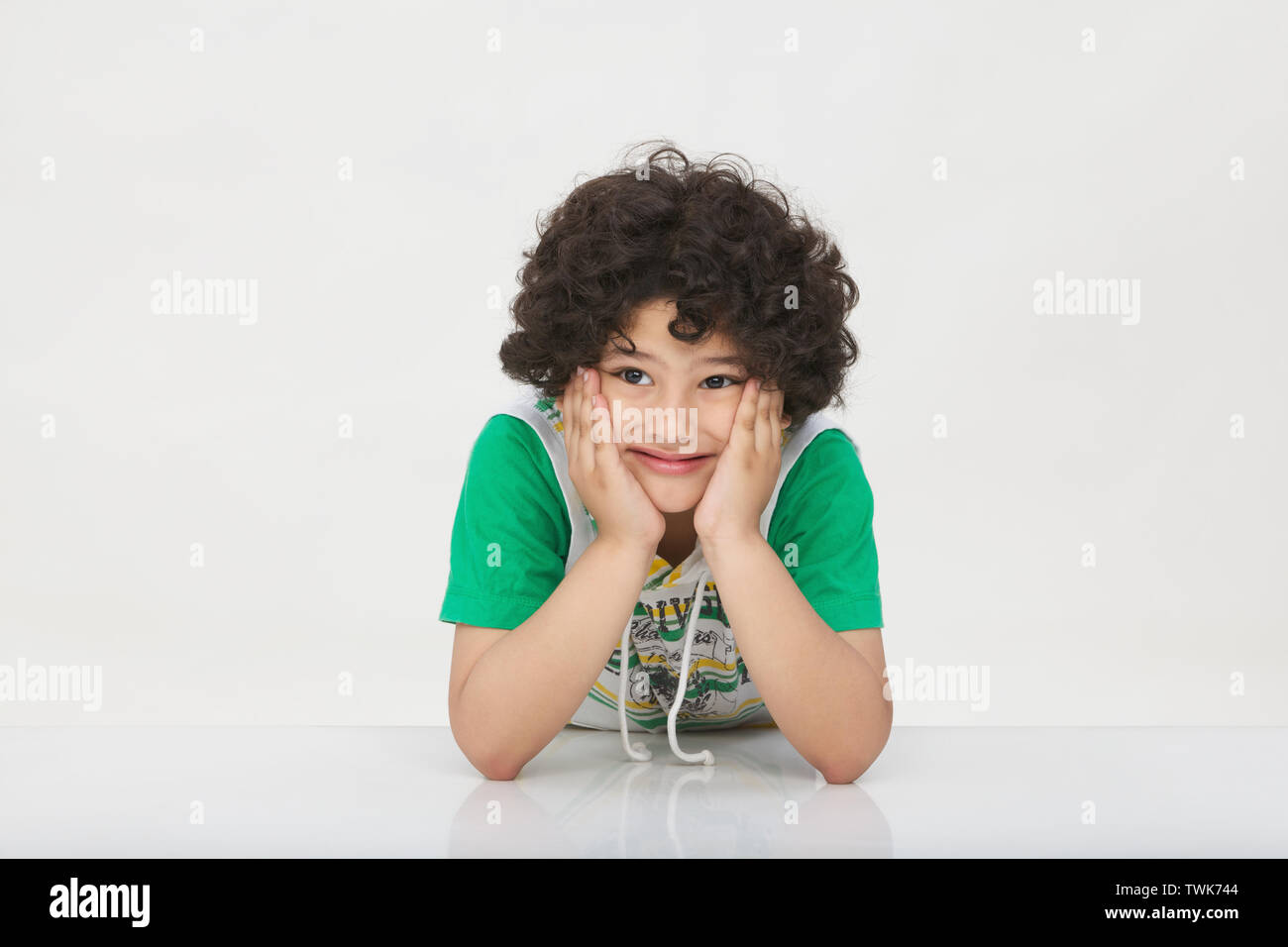 Boy with hand on cheeks Stock Photo - Alamy