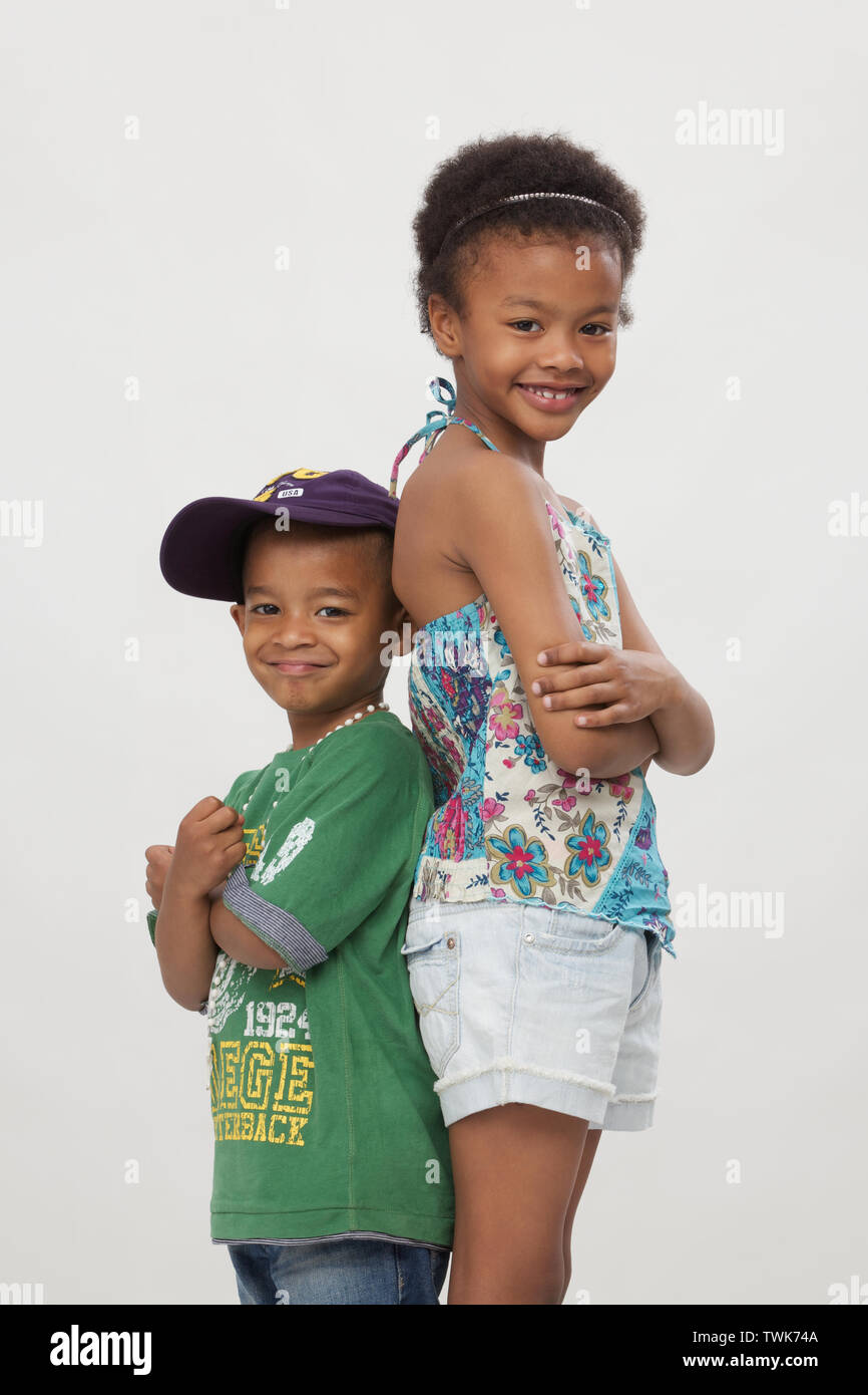 Two children standing back to back Stock Photo - Alamy