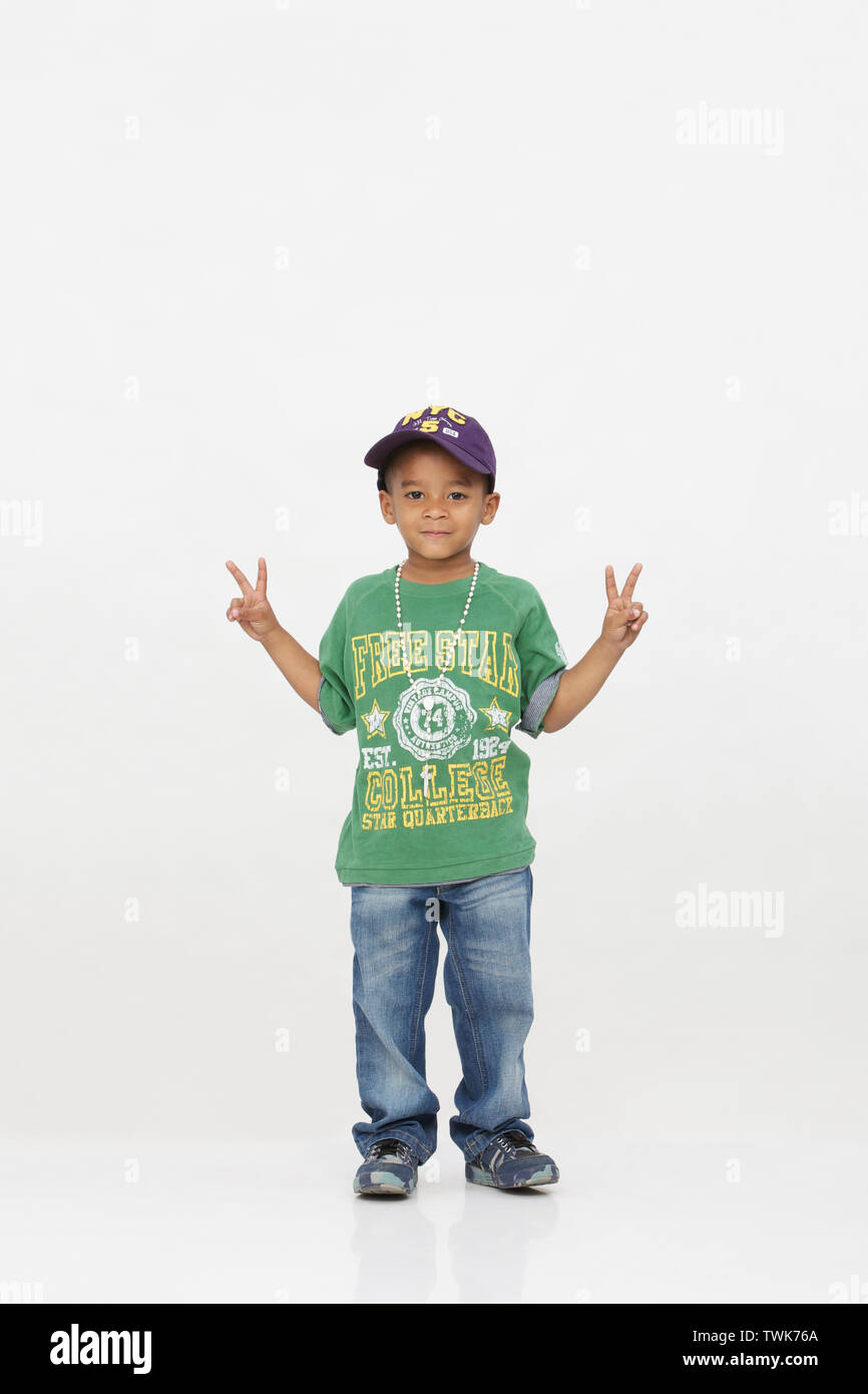 Portrait of a boy showing v sign Stock Photo - Alamy