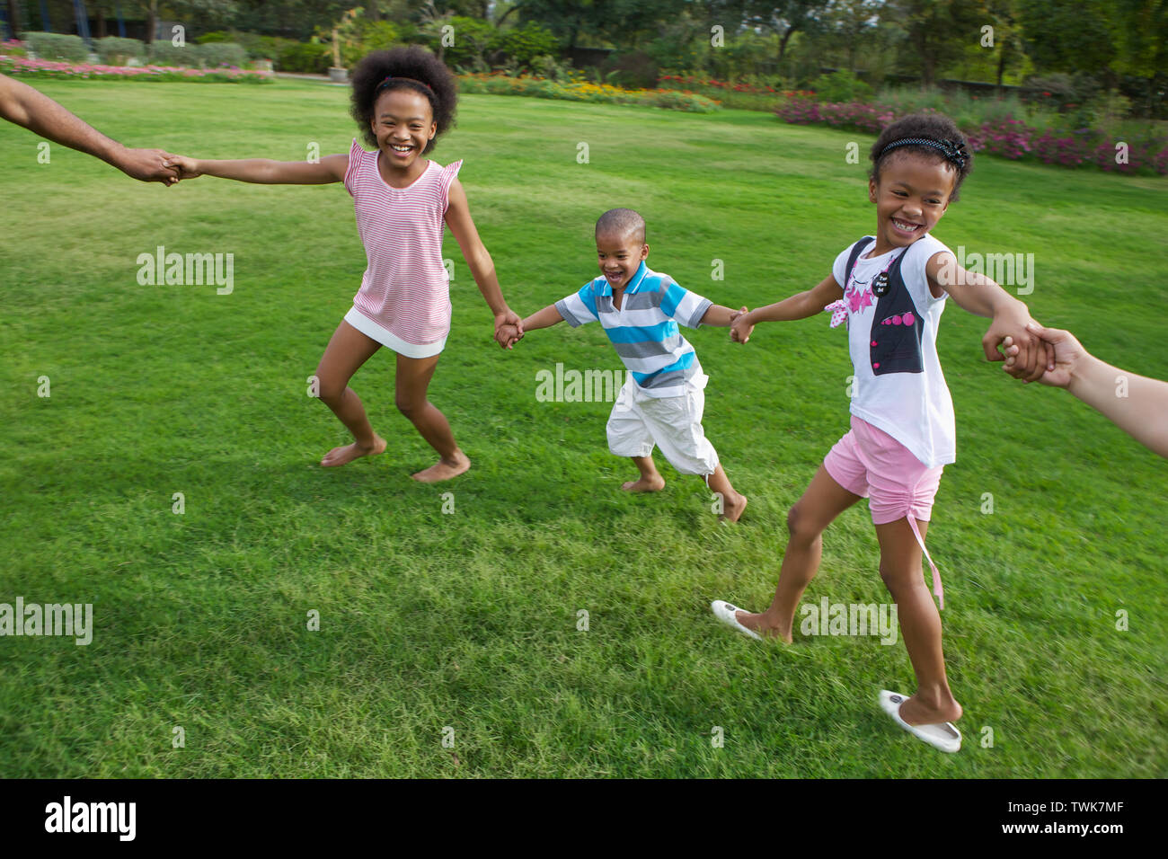 Children playing in a lawn Stock Photo - Alamy