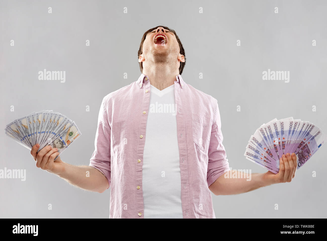 screaming young man with euro and dollar money Stock Photo - Alamy