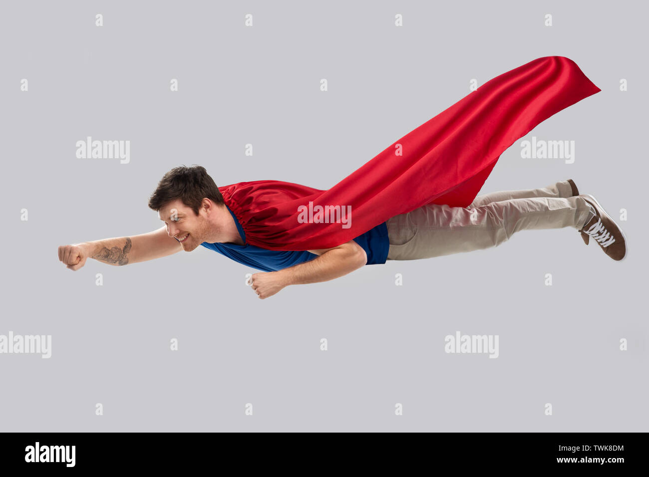 man in red superhero cape flying in air Stock Photo - Alamy